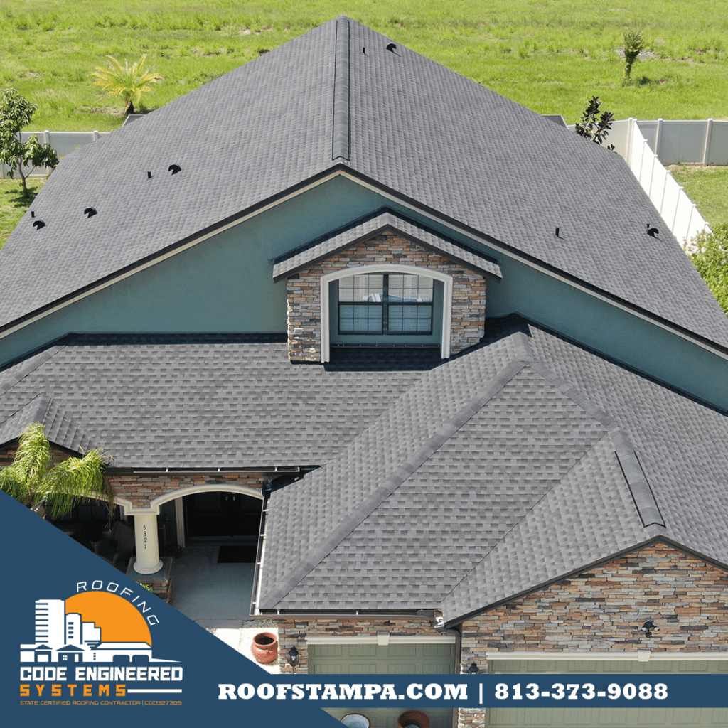 Charcoal Shingles On A Green House With Stone Cladding - Code ...